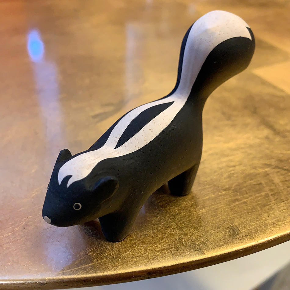 Home: Carved Wooden Skunk – The Gardener Store